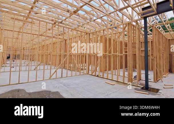 Workers build wooden beams frame for structure in an open space with ...