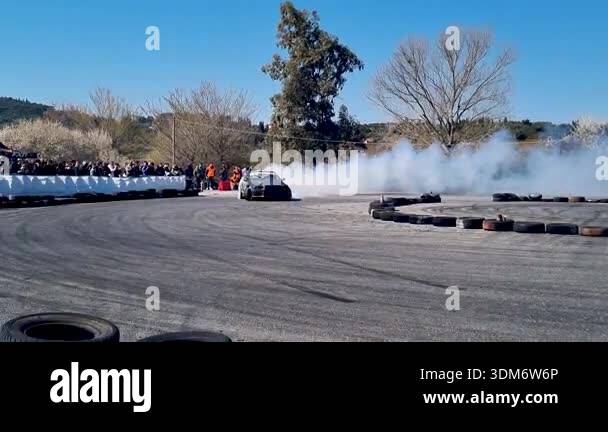 Car drifting around corner with smoke Stock Video Footage - Alamy