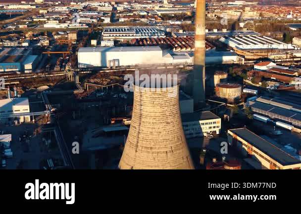 Cooling towers behind power plants and industrial buildings. Steam ...