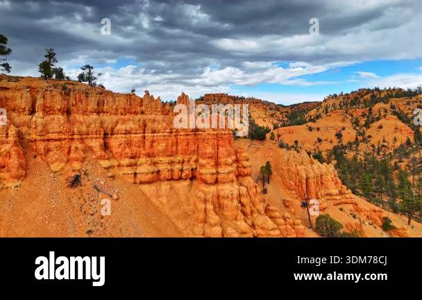 Columned rock formations in Red Canyon, Utah, USA. Scarce pine trees ...
