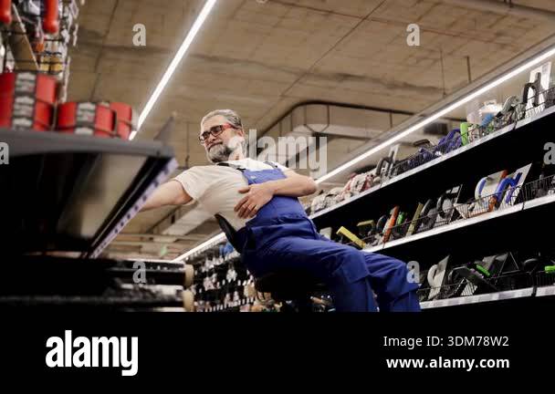 Construction worker selecting tools at a building materials store. Man ...