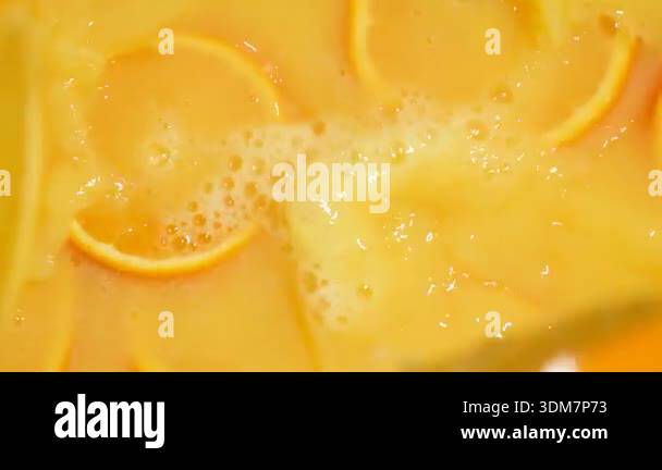 Fresh citrus orange fruit falling in slow motion into juice with ...