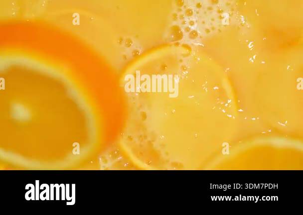 Refreshing orange juice explosion with falling fruit slices Stock Video ...