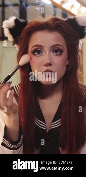 Cute and beautiful young woman with catchy anime makeup applying ...