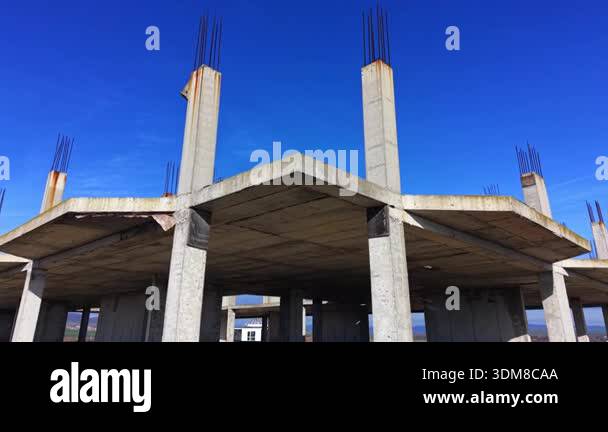 Low angle view of several concrete pillars with exposed steel rebar ...