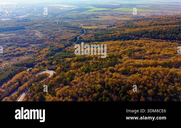 Forested mountain slope in autumn, a winding road, and a panoramic ...