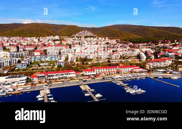 Wide shot of a yacht harbor with piers and upscale residential ...