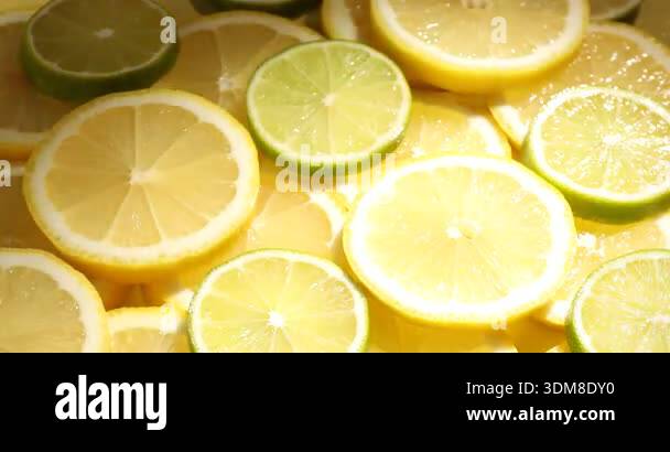 Fresh lime and lemon slices as background, closeup. Changing direction ...