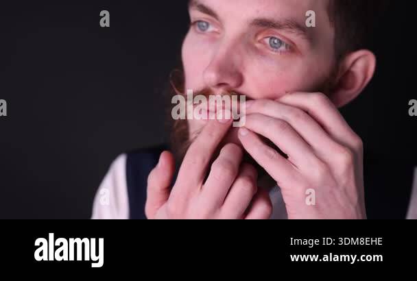Man styling his mustache on black background Stock Video Footage - Alamy