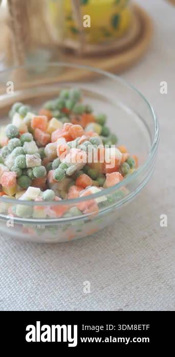 These frozen mixed vegetables show colors of peas and carrots Stock ...