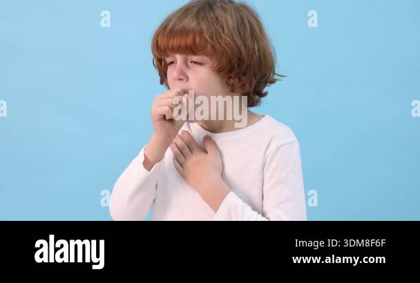 Little boy coughing on light blue background. Cold symptom Stock Video ...