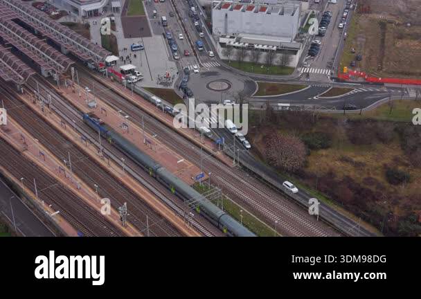 High-angle perspective showing a passenger train pulling into a modern ...