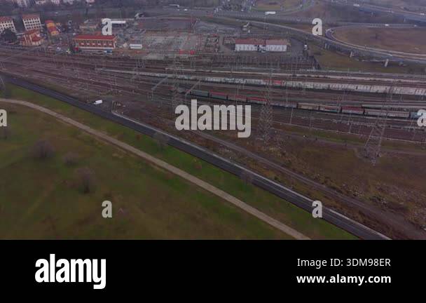 High-speed passenger train and a freight train passing through a large ...