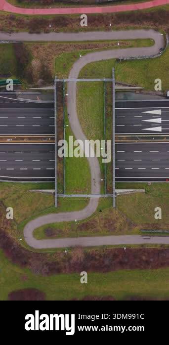 Top-down aerial view of a pedestrian and bicycle bridge crossing over a ...