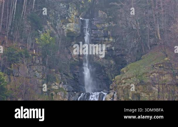 A scenic multi-tiered waterfall on a mountain stream dropping from ...