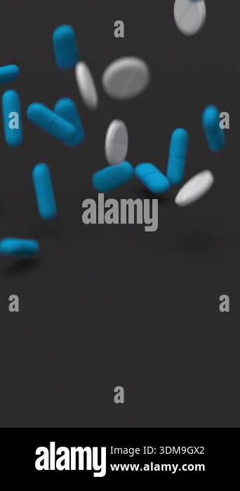 Blue and white tablets falling on black background in slow motion ...