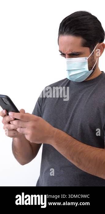 Serious man angry and nervous is using smartphone and face mask safe ...