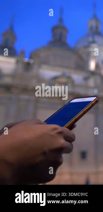 Asian woman using smartphone with the Cathedral-Basilica of Our Lady of ...