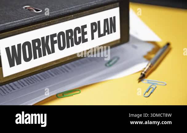 Workforce planning strategy binder with paper and pen for effective ...