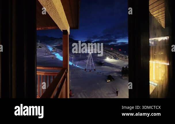 Experience the peaceful beauty of a ski resort at night. Illuminated ...