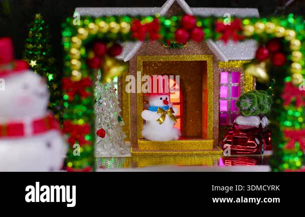 A yellow car drives past a Christmas house with a snowman on the porch ...