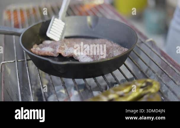 Grilling Beef In Cast Iron Pan On Charcoal Stove, A sizzling film clip ...