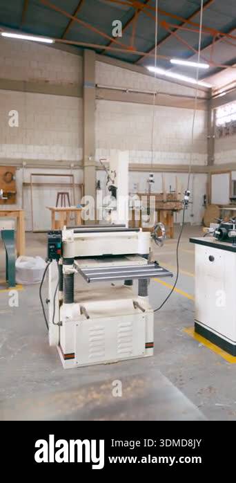 Professional woodworking planer machine standing in a large, well lit ...