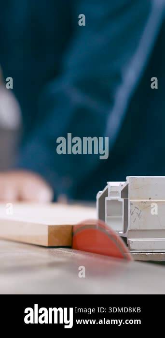 Close up view of a professional carpenter using a circular table saw to ...