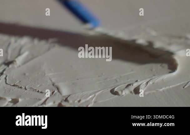 Close up of textured paste spread on canvas surface with visible relief ...