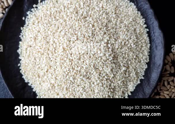 White sesame seeds in a bowl, an ingredient for oil and healthy eating ...