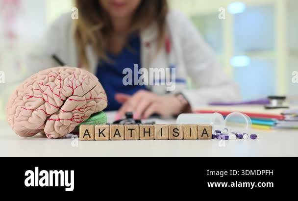 Wooden cubes on table form term Akathisia near anatomical model of ...