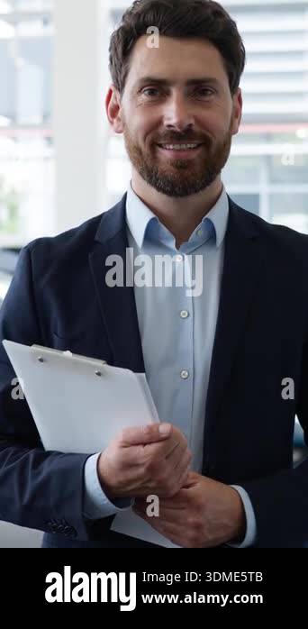 Smiling Caucasian car dealer business man looking camera inside auto ...