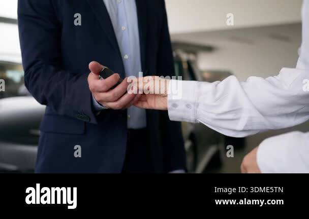 Consultant give bunch of keys of new car auto in showroom happy man ...