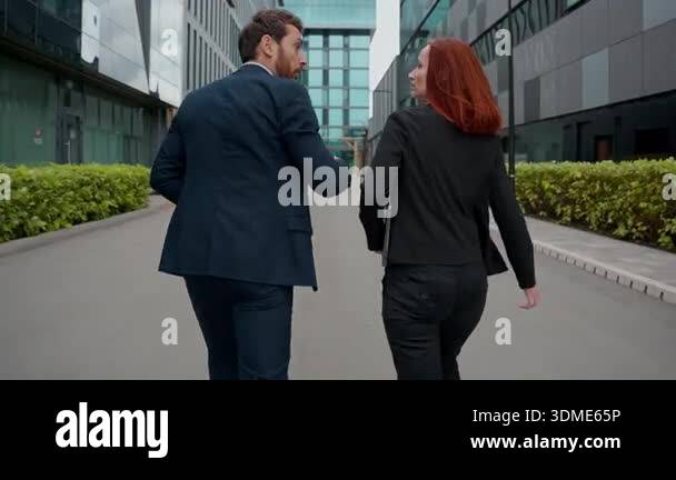 Corporate managers business man woman walk in city talking late running ...