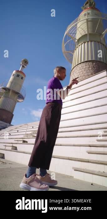 Dynamic low angle slow motion shot of a stylish person with short hair ...