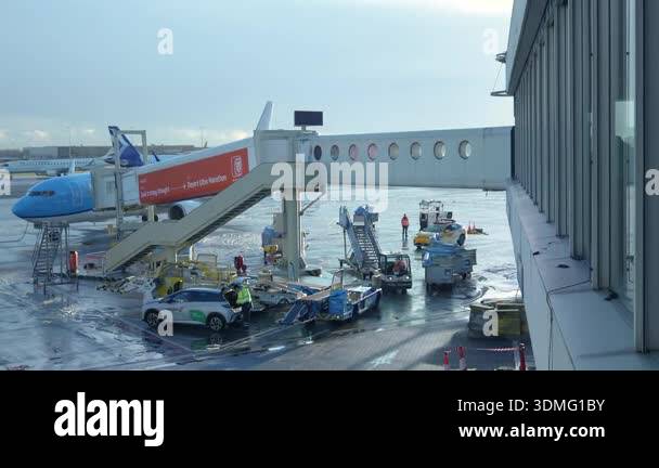 Airport Apron Jet Bridge Loading Baggage Crew Coordinating On Wet ...