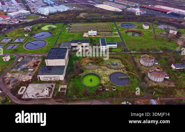 Aerial view of a wastewater treatment site with several large circular ...