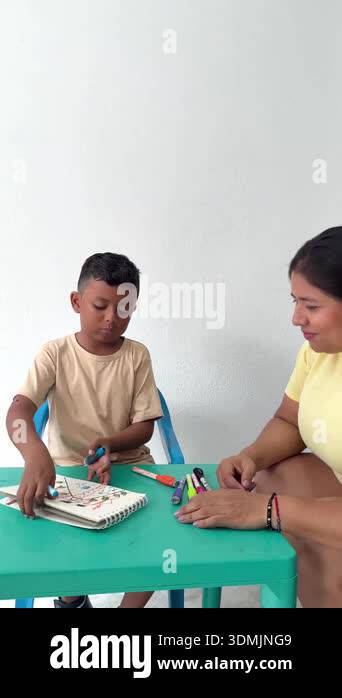 Hispanic mother and her son drawing together and hugging, isolated on a ...