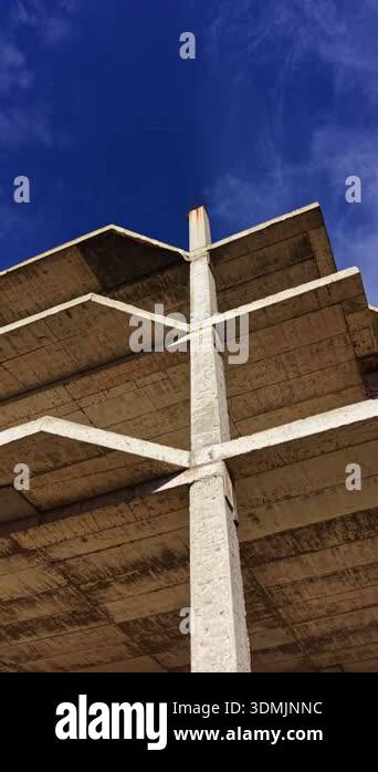 A concrete structure reaches upwards with precise lines and angles ...