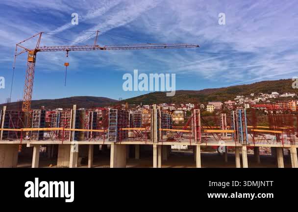 Workers can be seen actively constructing a multi-story building. A ...
