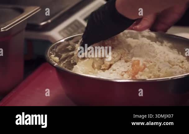 Cooking process. Mixing dough. Professional chef hand in gloves ...