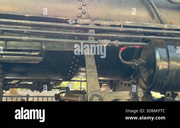 Closeup view of pipes, rods and metal components runs along the side of ...