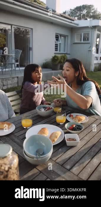 A 3 Generation Multi Ethnic Asian Family Eating Breakfast OutsideHigh ...