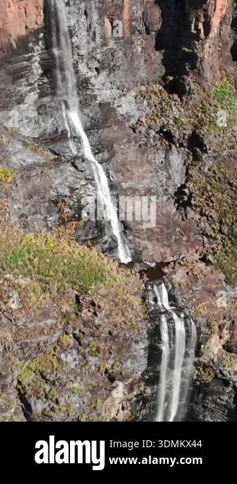 close view of vertical waterfall, powerful cascade drops along basalt ...
