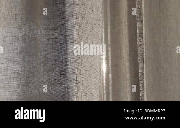 Natural white linen curtain with rough fabric texture, backlit by ...