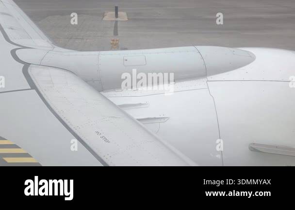 A detailed view of an aircraft wing and engine, showcasing the ...