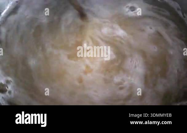 Dynamic movement of water in a swirling motion creates an abstract and ...