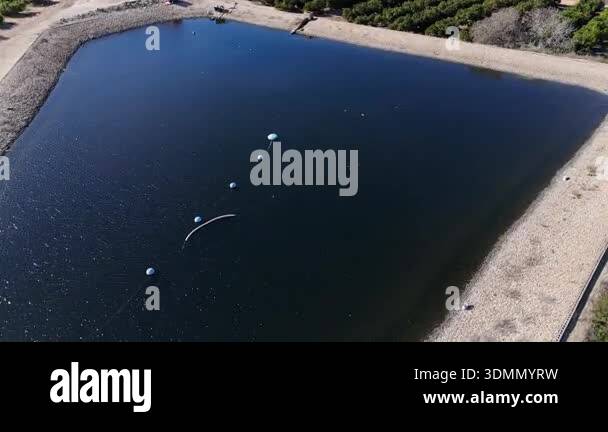Drone aerial view of agricultural irrigation reservoir with dark water ...