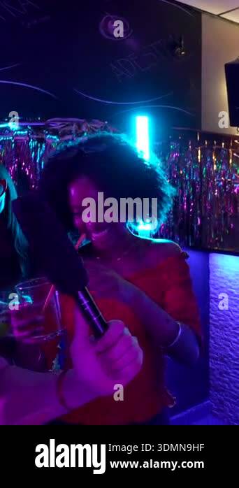 Young multi ethnic friends dancing, singing with a microphone, and ...