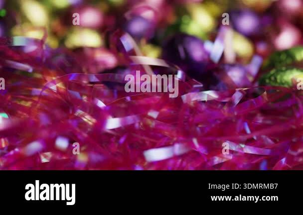 Abstract macro shot of bright pink metallic tinsel strips with blurred ...